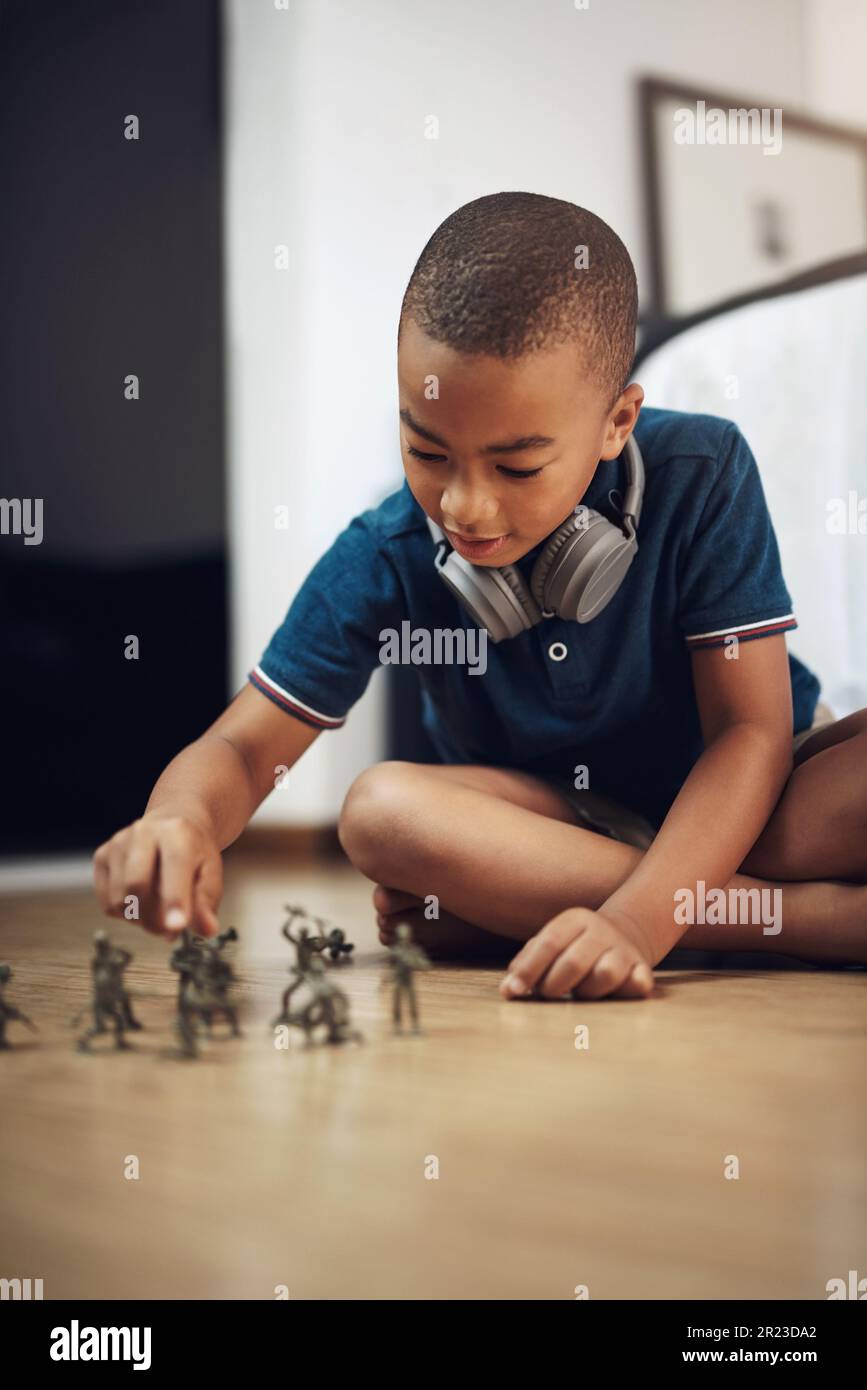 Having fun with his little soldiers. a young boy playing with toy ...