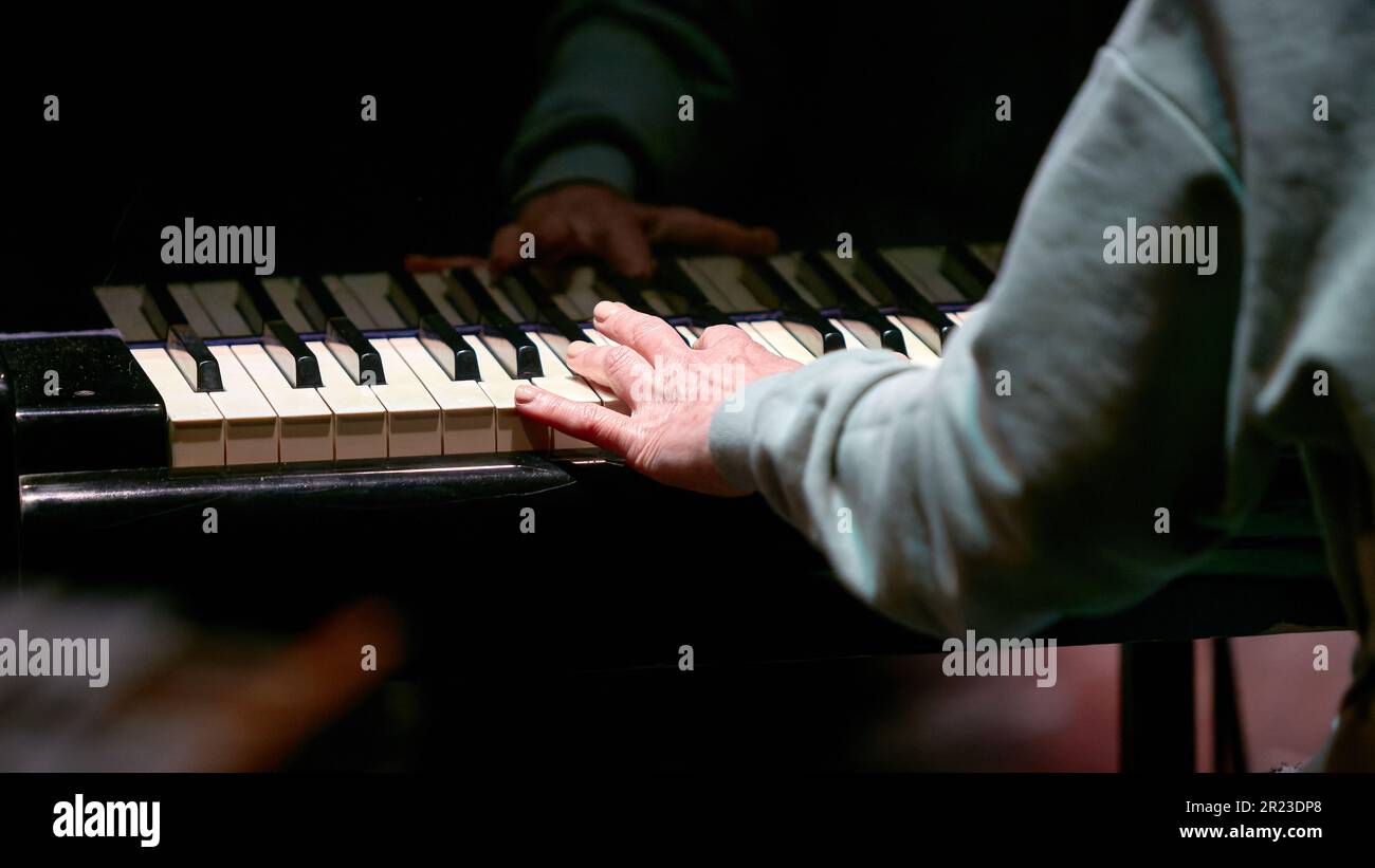The image of the left hand on playing the piano keys Stock Photo - Alamy