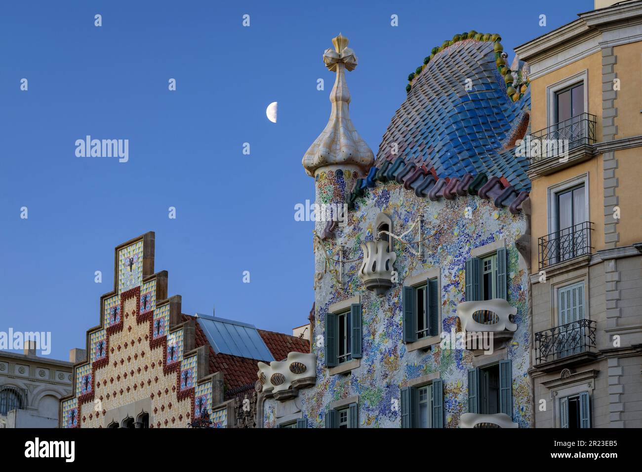 Sunrise over the roof of the Casa Batlló with the waning moon behind ...