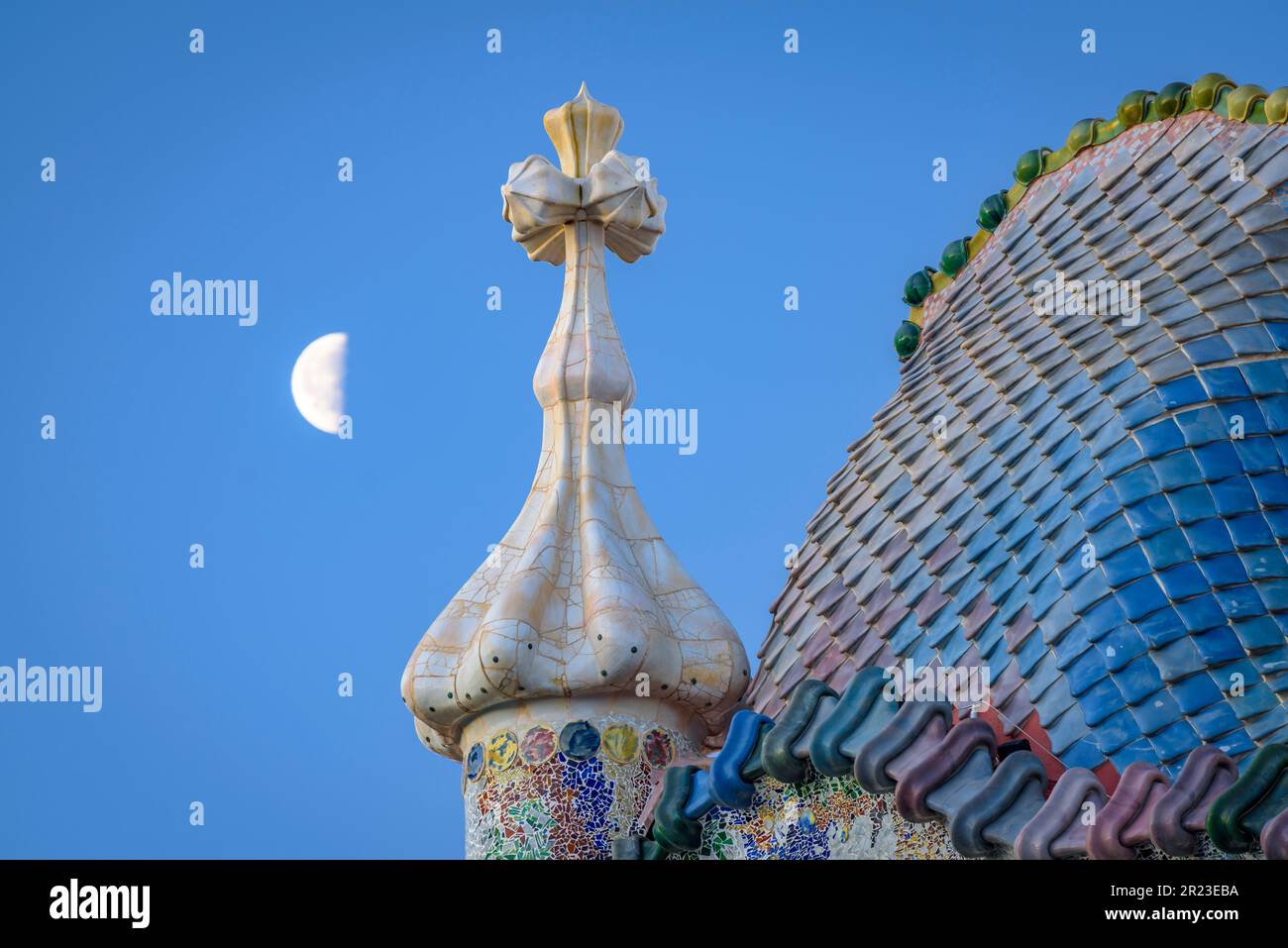 Sunrise over the roof of the Casa Batlló with the waning moon behind ...