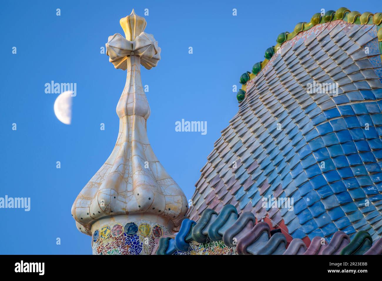 Sunrise over the roof of the Casa Batlló with the waning moon behind ...