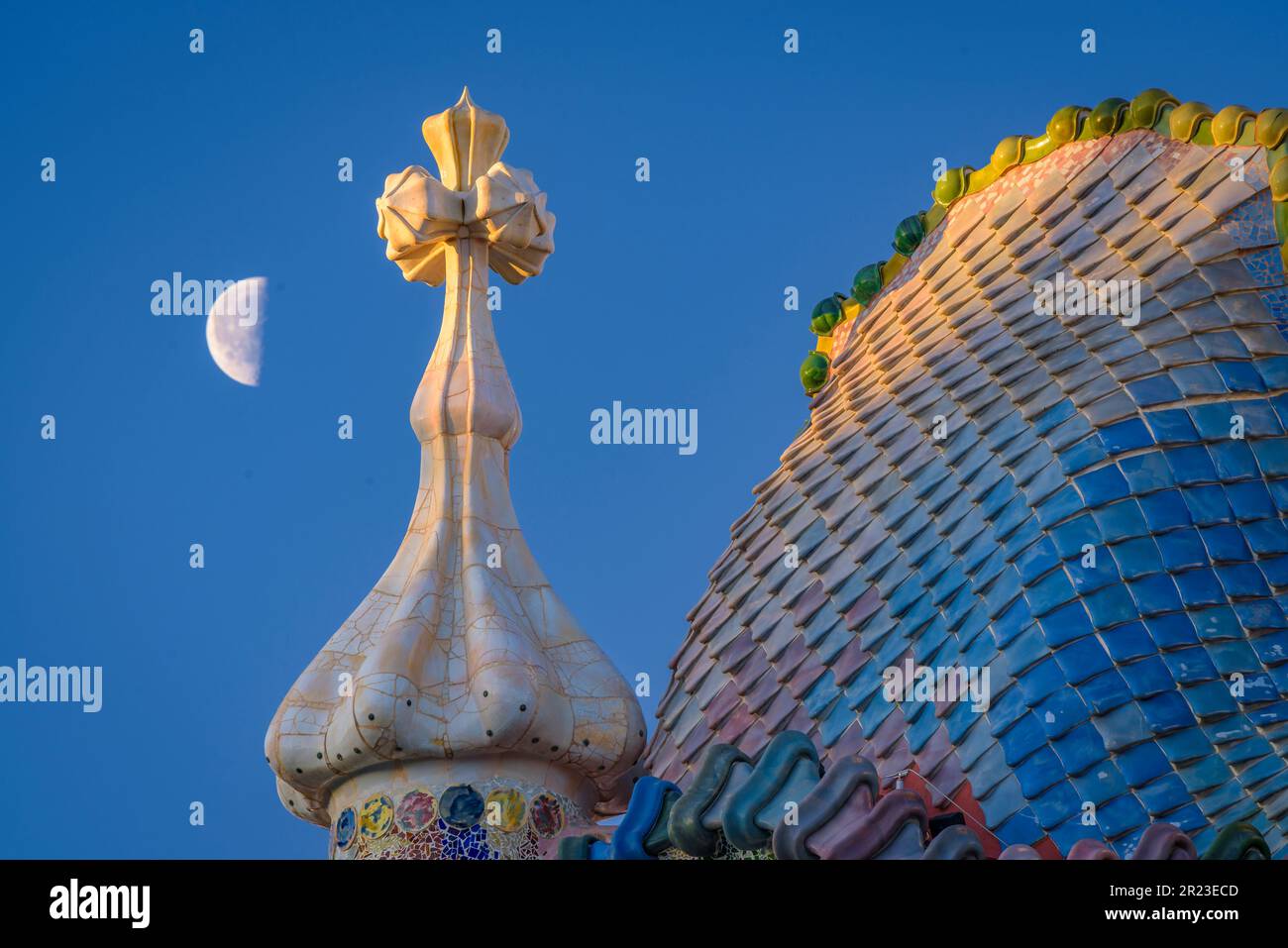Sunrise over the roof of the Casa Batlló with the waning moon behind ...