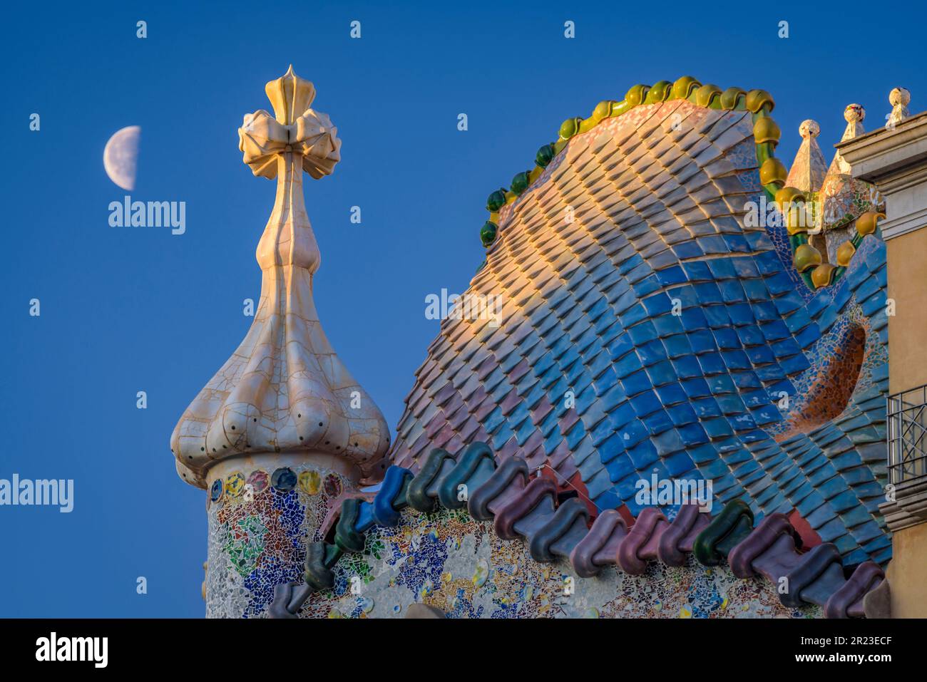 Sunrise over the roof of the Casa Batlló with the waning moon behind ...
