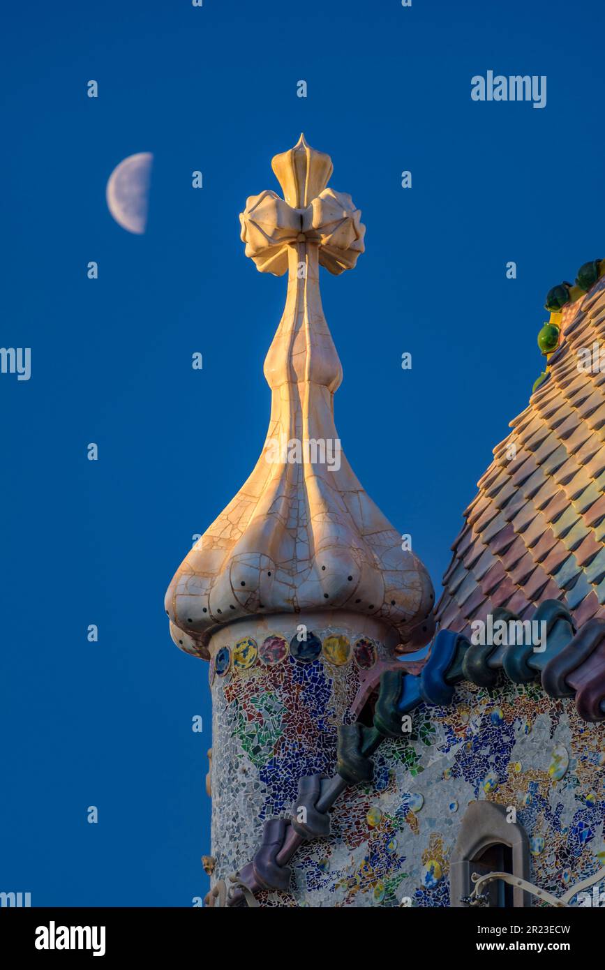 Sunrise over the roof of the Casa Batlló with the waning moon behind ...