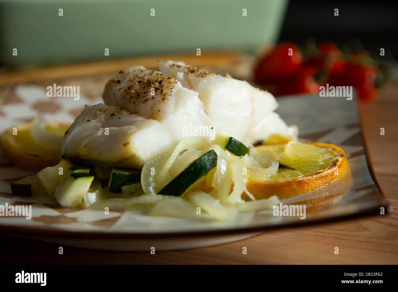 Baked cod with vegetables, lemon and zucchini Stock Photo - Alamy