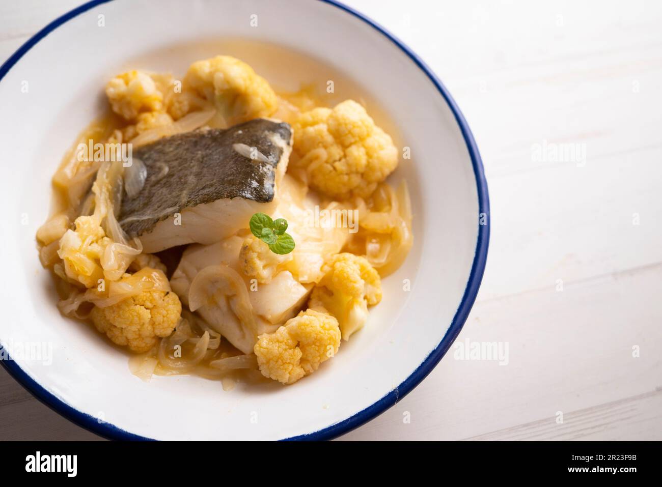 Cod cooked with vegetables, cauliflower and potatoes Stock Photo - Alamy
