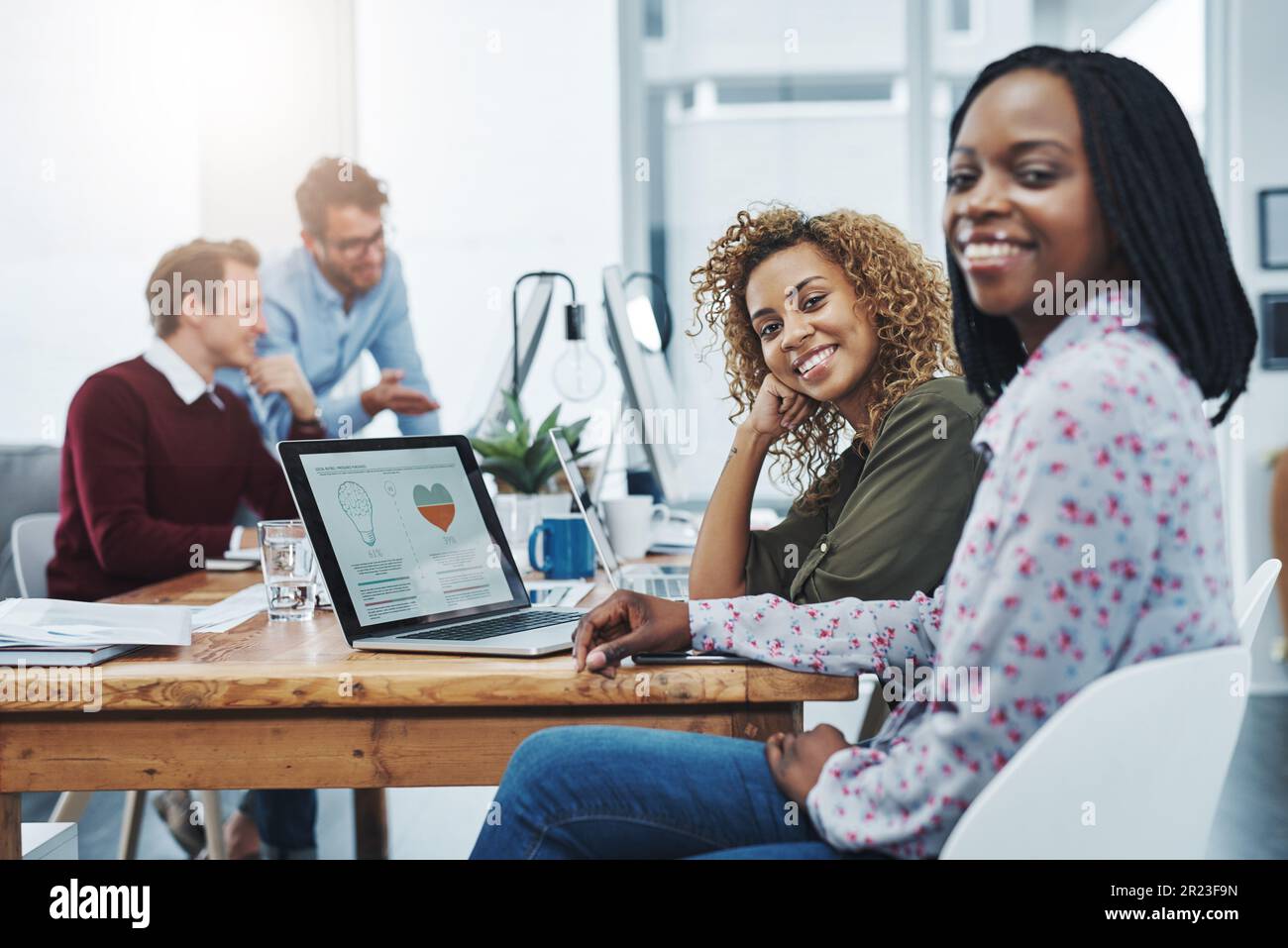 Best company to work for, ever. two young colleagues using a laptop ...