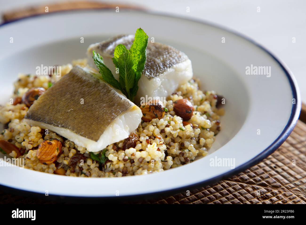 Baked cod with vegetables, nuts and quinoa Stock Photo - Alamy