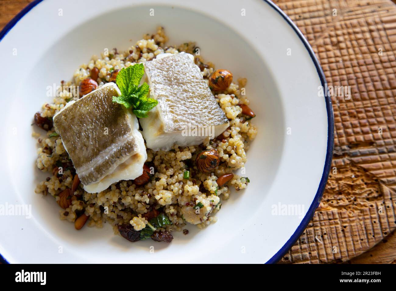 Baked cod with vegetables, nuts and quinoa Stock Photo - Alamy