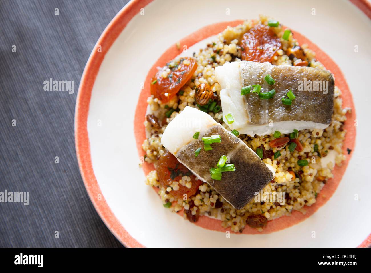 Baked cod with vegetables, nuts and quinoa Stock Photo - Alamy