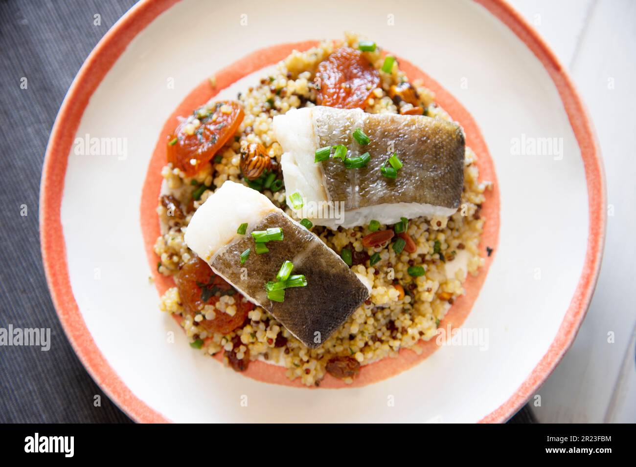 Baked cod with vegetables, nuts and quinoa Stock Photo - Alamy