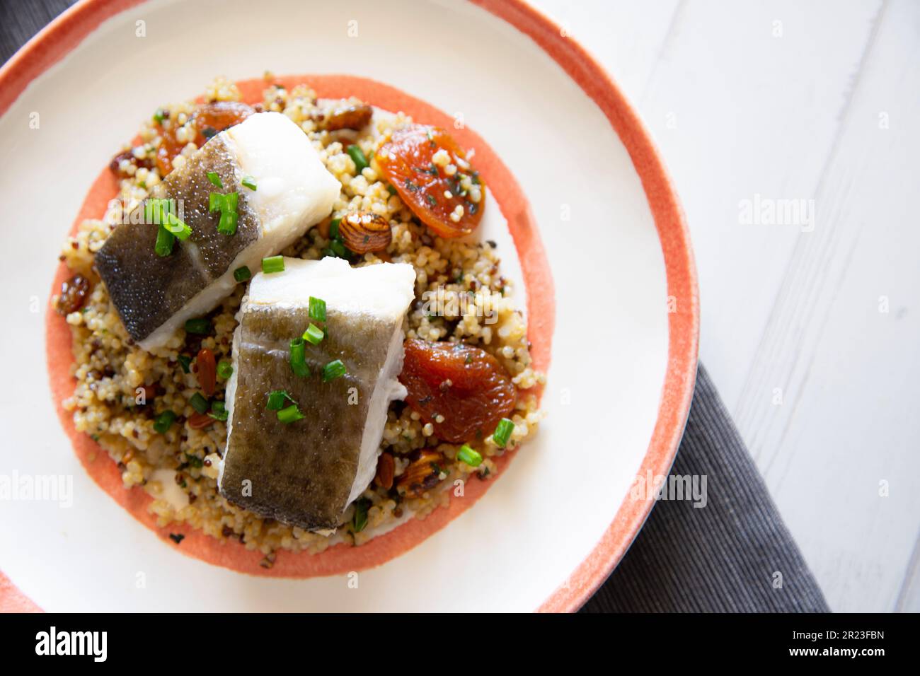 Baked cod with vegetables, nuts and quinoa Stock Photo - Alamy