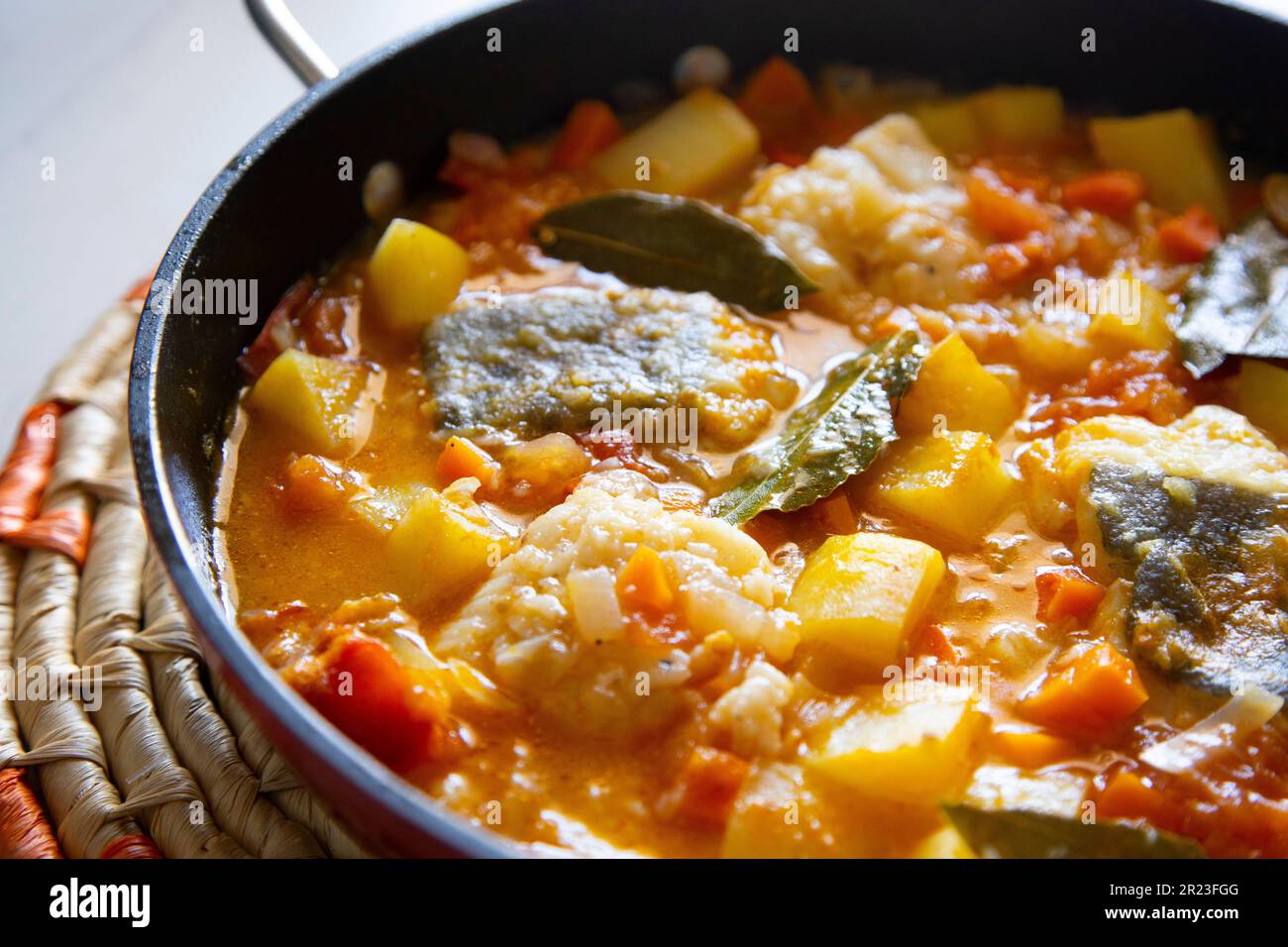 Stewed cod with vegetables, potatoes and tomatoes Stock Photo - Alamy