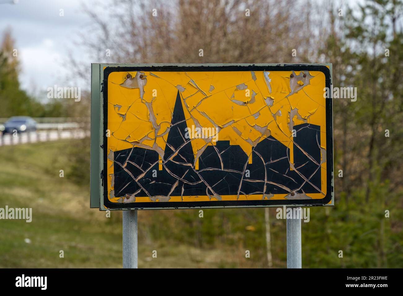 Yellow Built-up area road sign with cracked flaking paint in Finland ...
