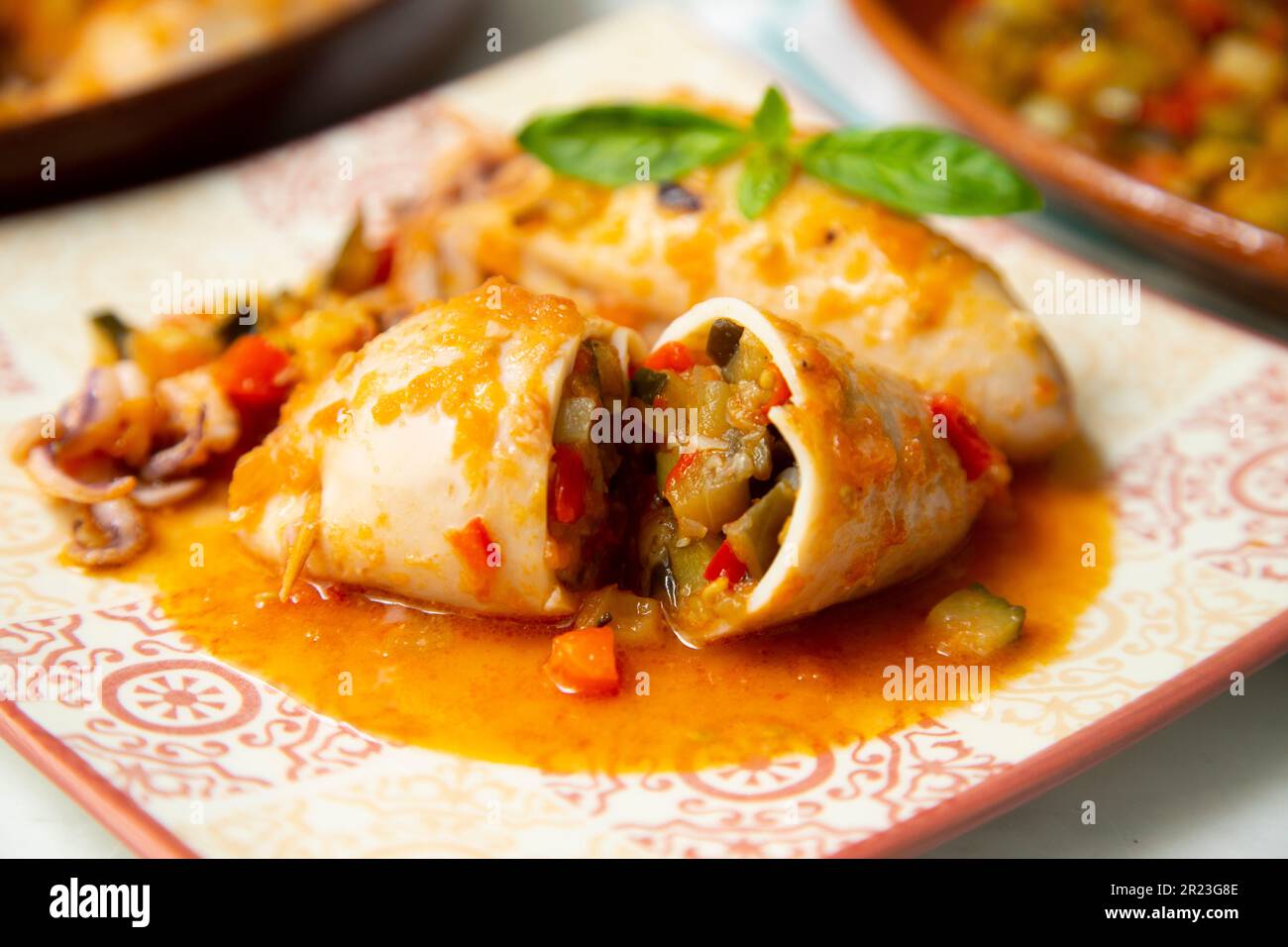 Squid stuffed with meat and vegetables. Traditional Spanish recipe ...