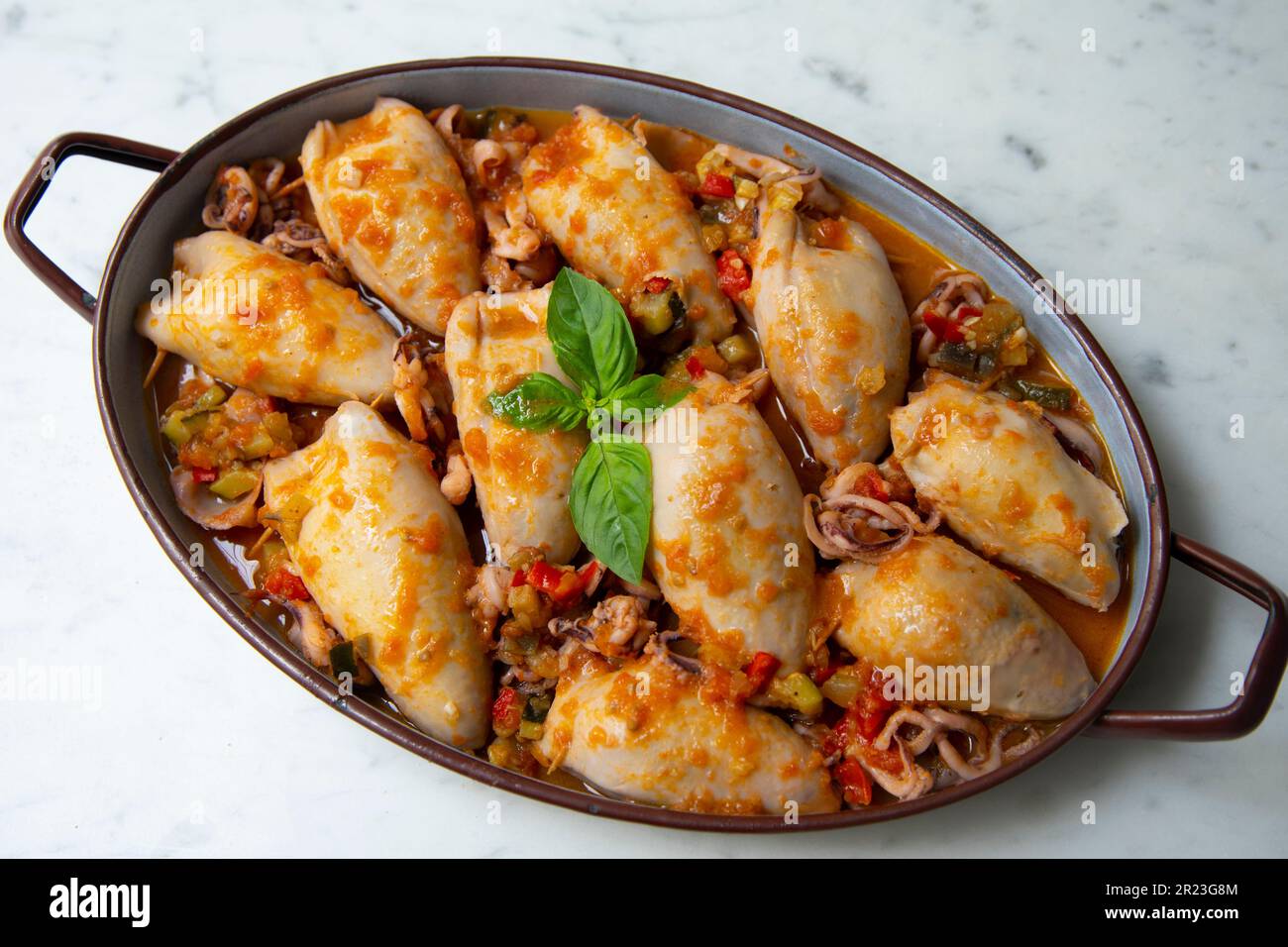 Squid stuffed with meat and vegetables. Traditional Spanish recipe ...