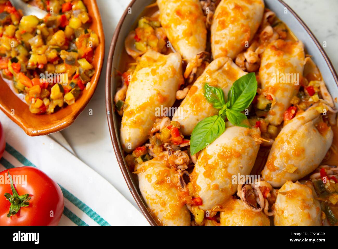 Squid stuffed with meat and vegetables. Traditional Spanish recipe ...