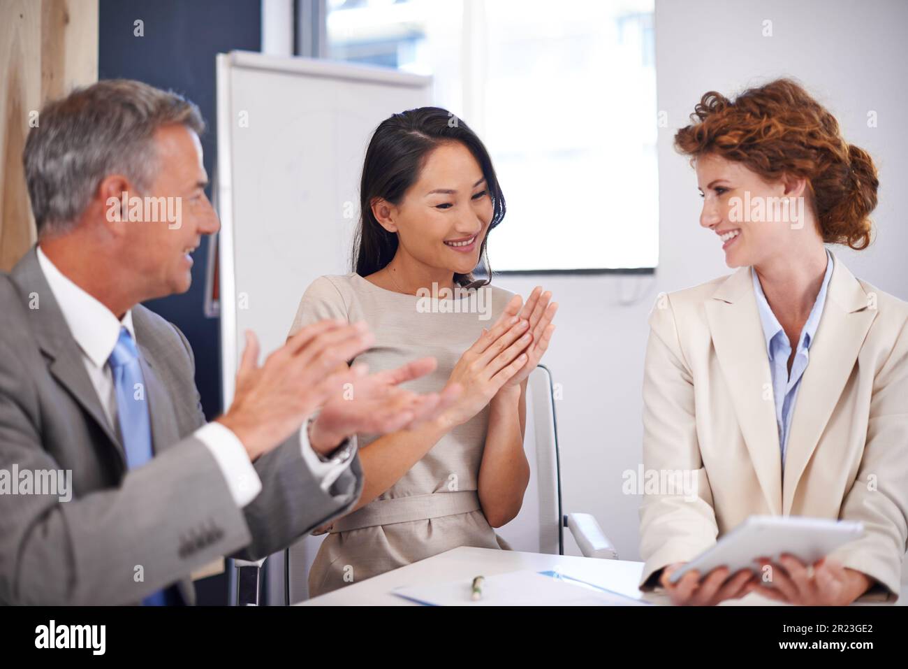 Congratulations on a job well done. two businesspeople congratulating ...