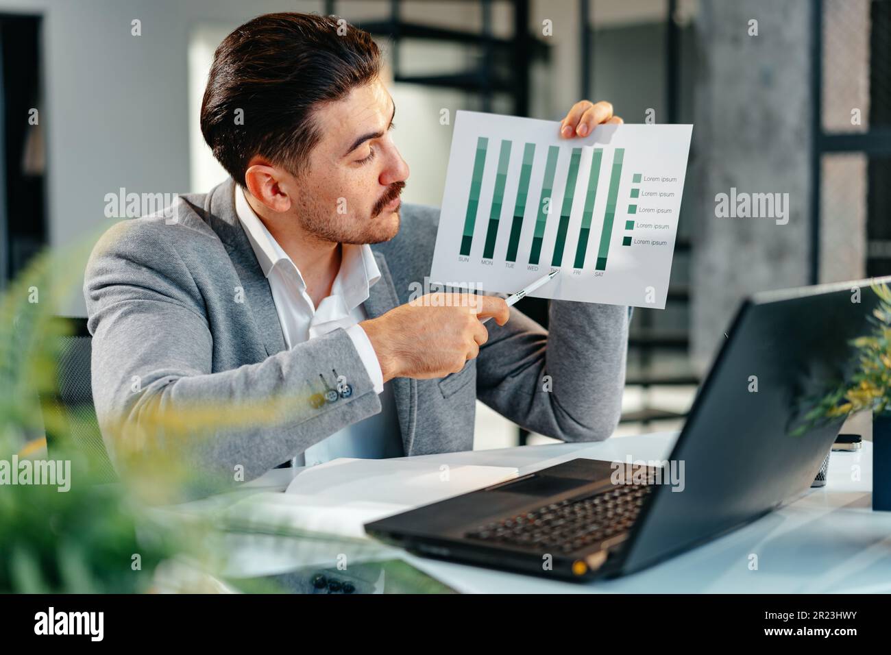 Businessman holding paper charts hi-res stock photography and images ...