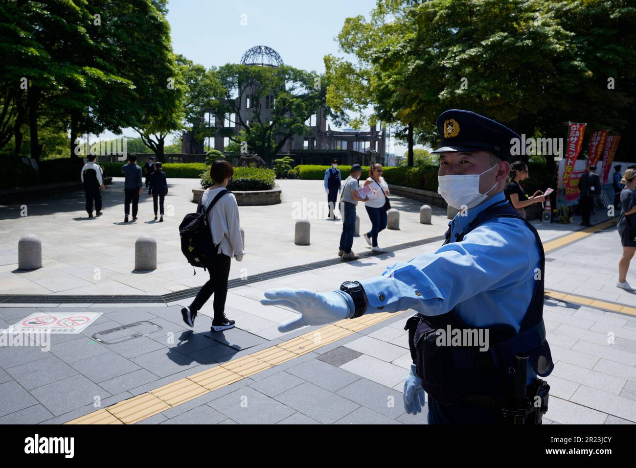 A police officer directs pedestrians near the famed Atomic Bomb Dome as ...