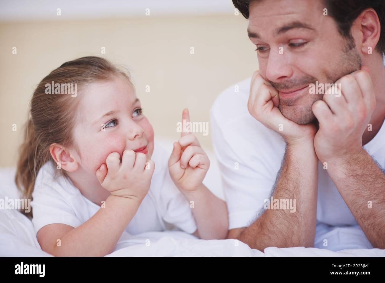Devoted to his daughters happiness. a father and daughter lying side by ...
