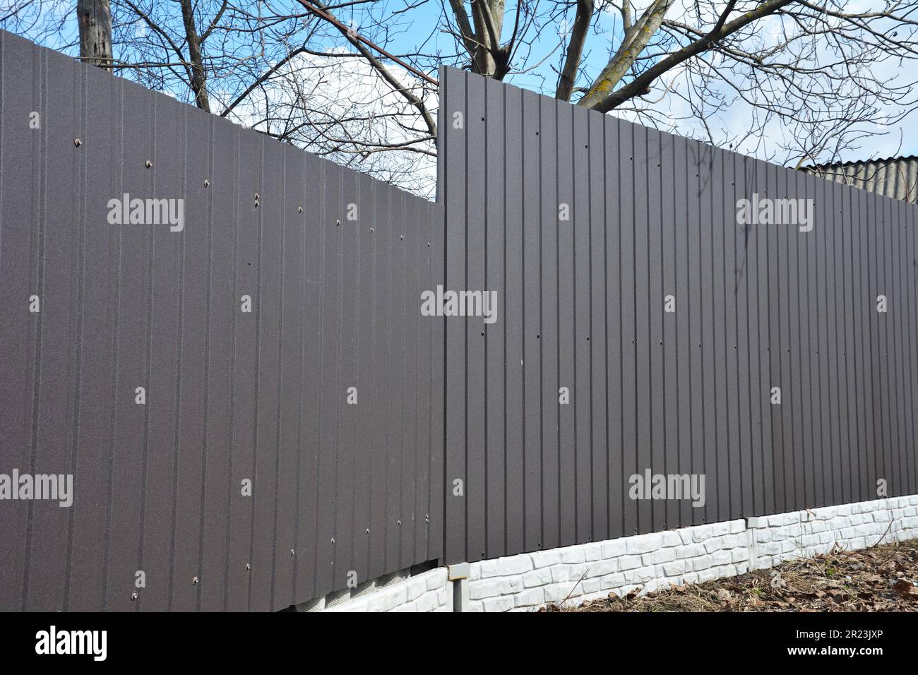 Close up on metal fence with concrete foundation boards Stock Photo - Alamy