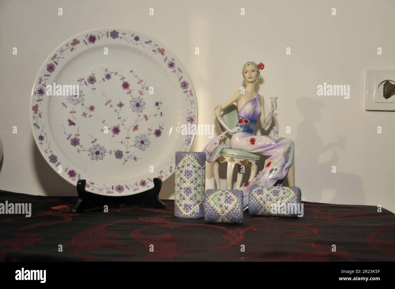Porcelain plate and porcelain lady figurine Stock Photo - Alamy