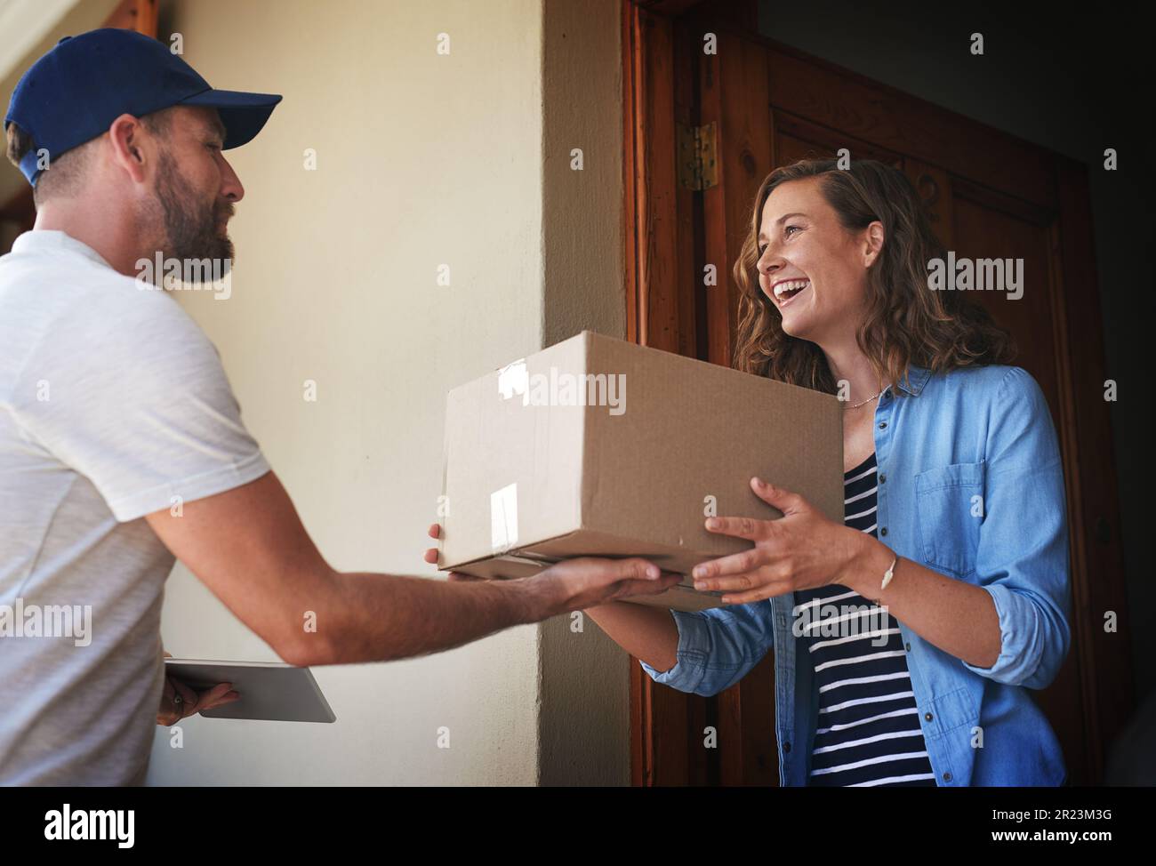 Happy woman, delivery man and package box at door for order, parcel or ...