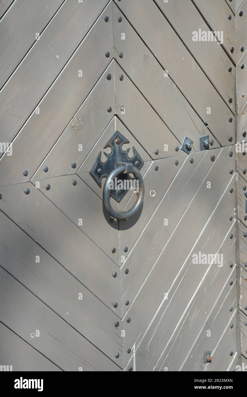 Wooden door with a round iron handle Stock Photo - Alamy