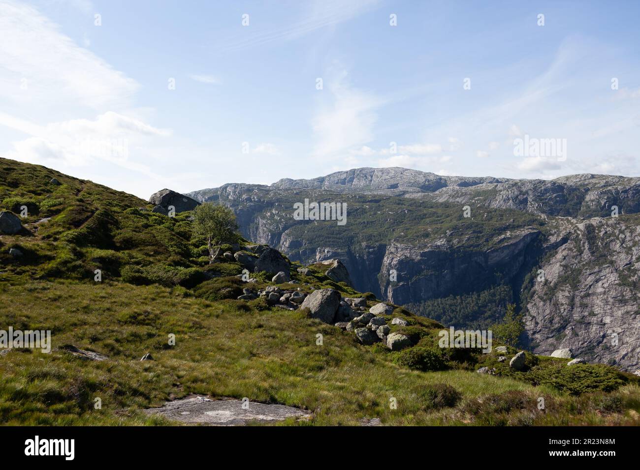 A scenic mountain valley in the countryside, featuring lush green grass ...