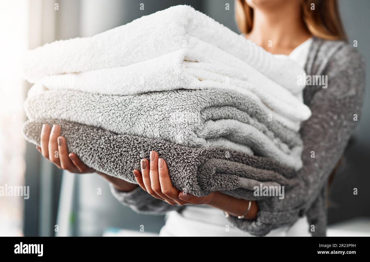 Hands, laundry and woman with towel stack for spring cleaning linen ...