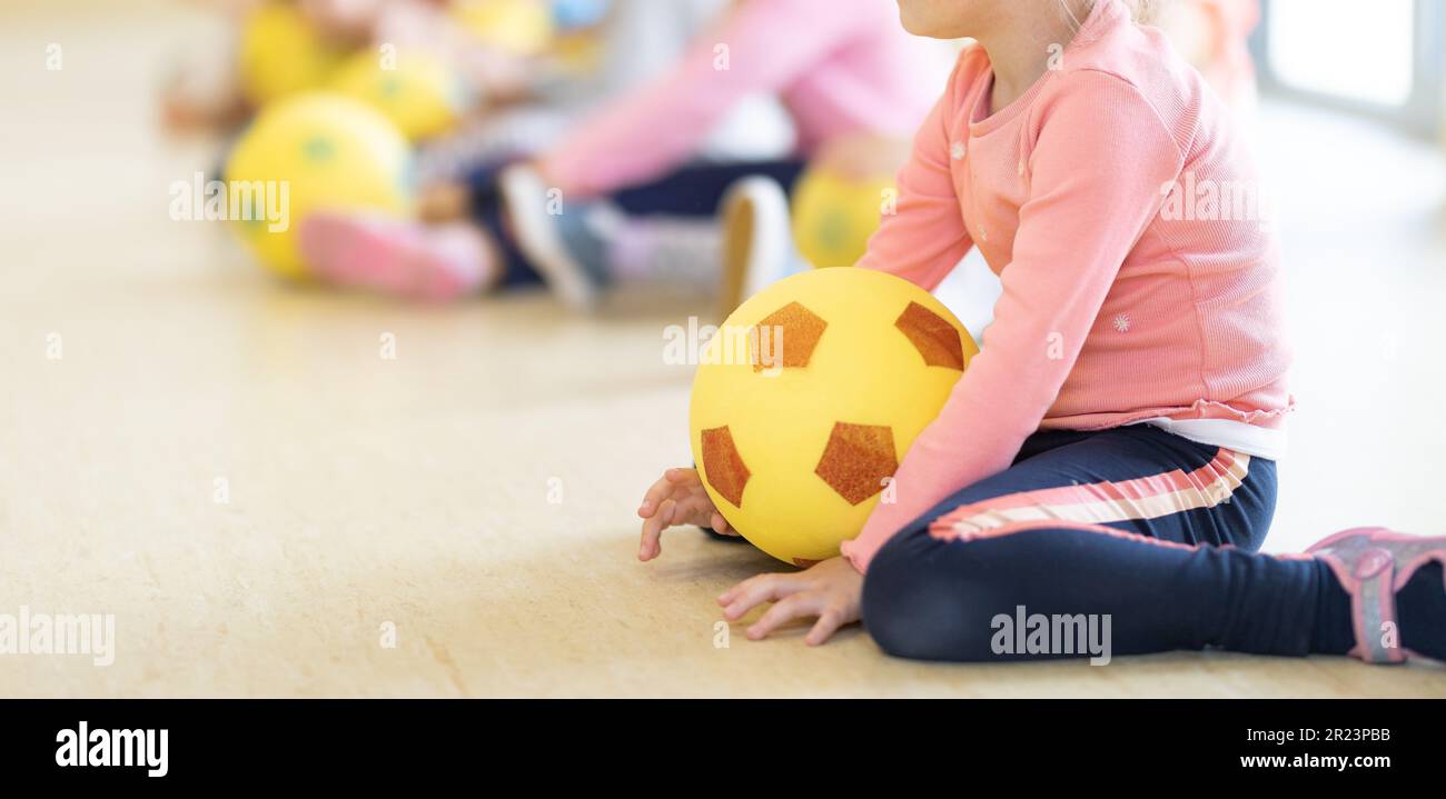 Children in kindergarten at soccer class. Little girl with foam soccer ...