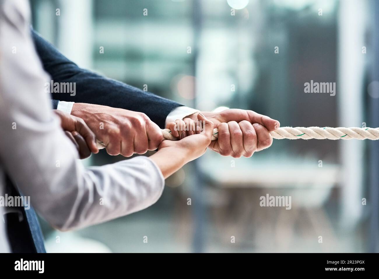 Hands, teamwork and rope with business people grabbing during a game of ...