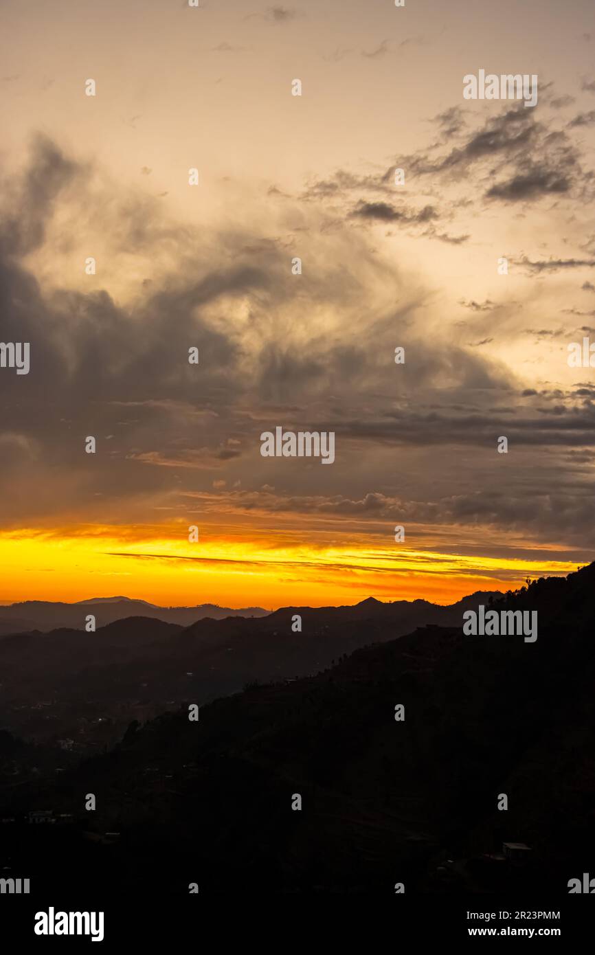 colorful magnificent sunset in countryside above hills and fields ...