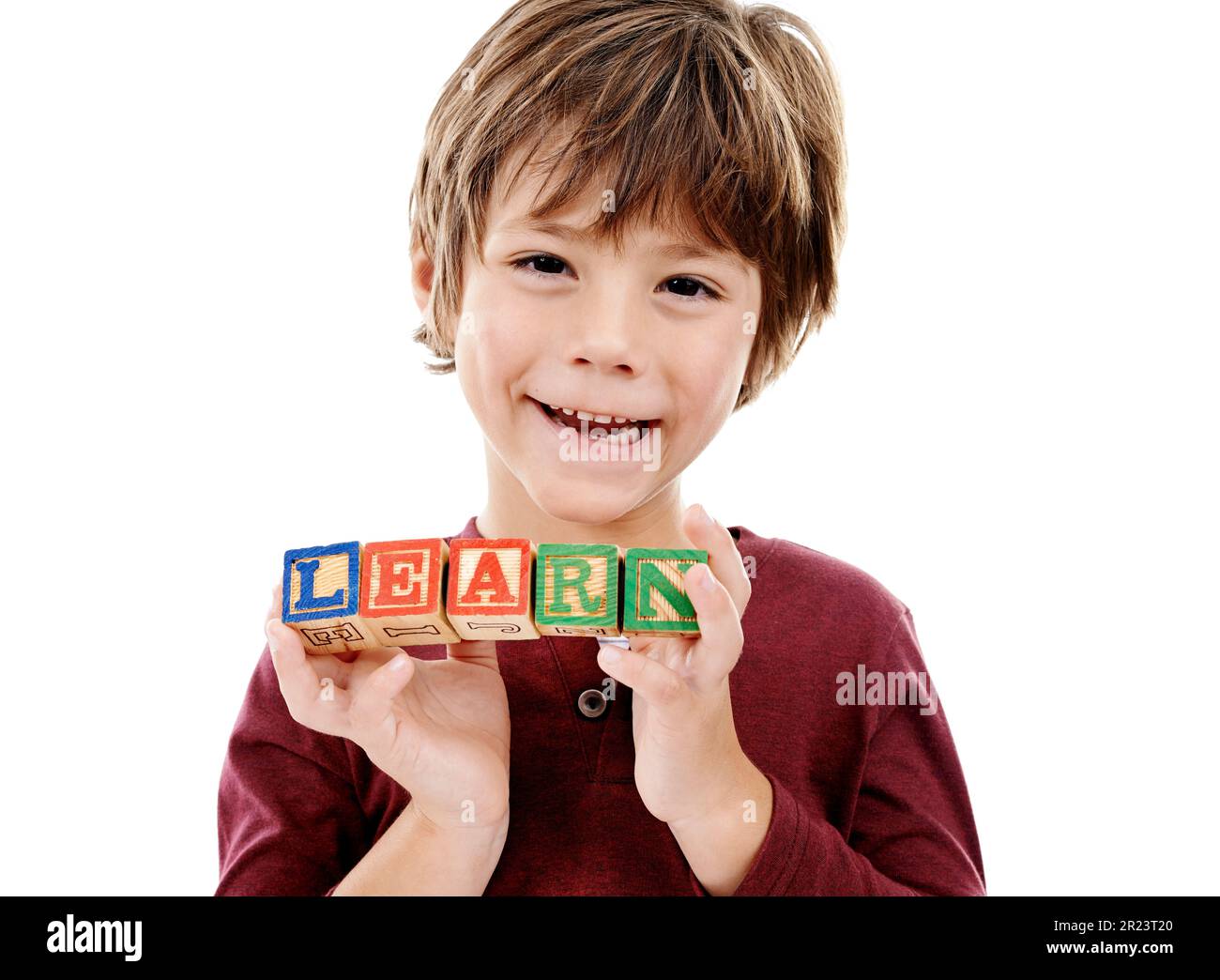 Learning through play. Studio shot of a cute little boy holding ...