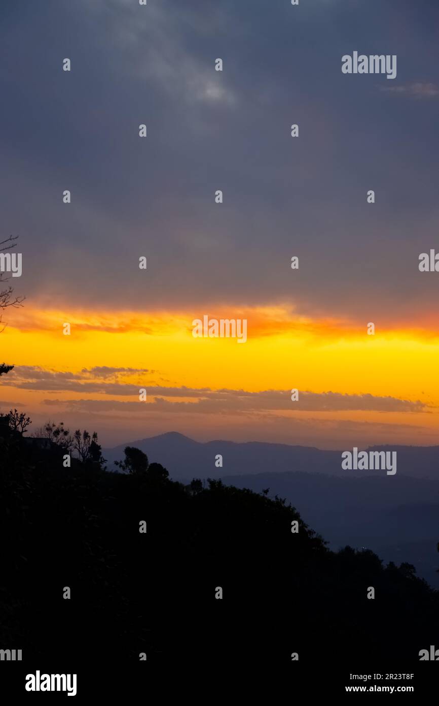 colorful magnificent sunset in countryside above hills and fields ...