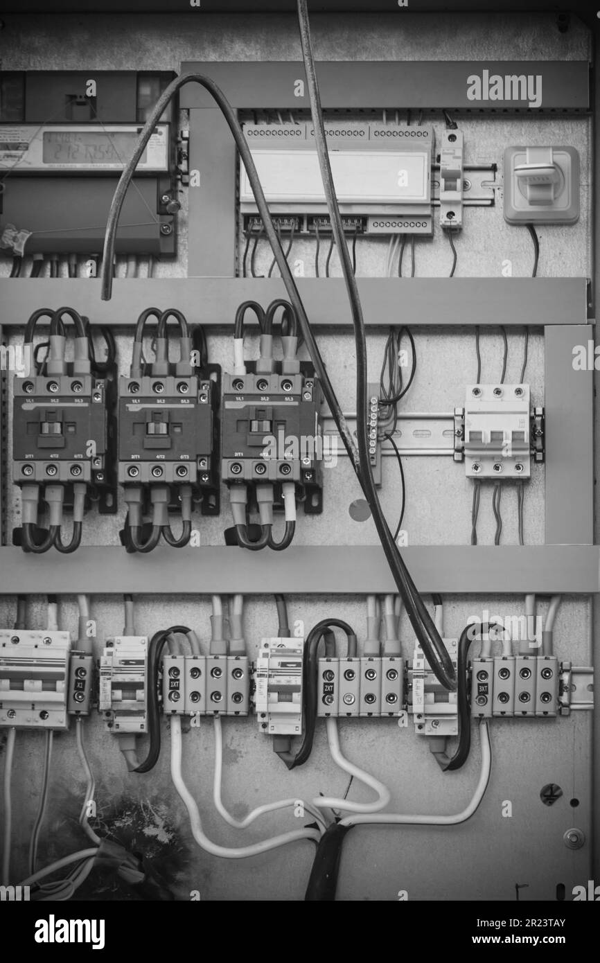 Burnt out wiring in switchboard with toggle switches in black and white ...