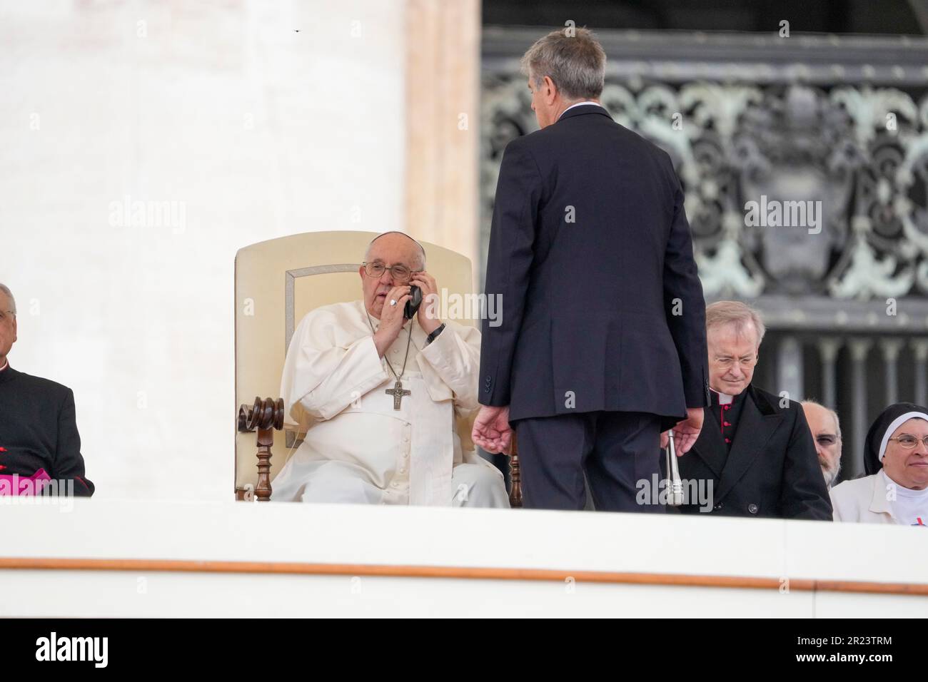 Pope Francis talks on the phone during his weekly general audience in ...