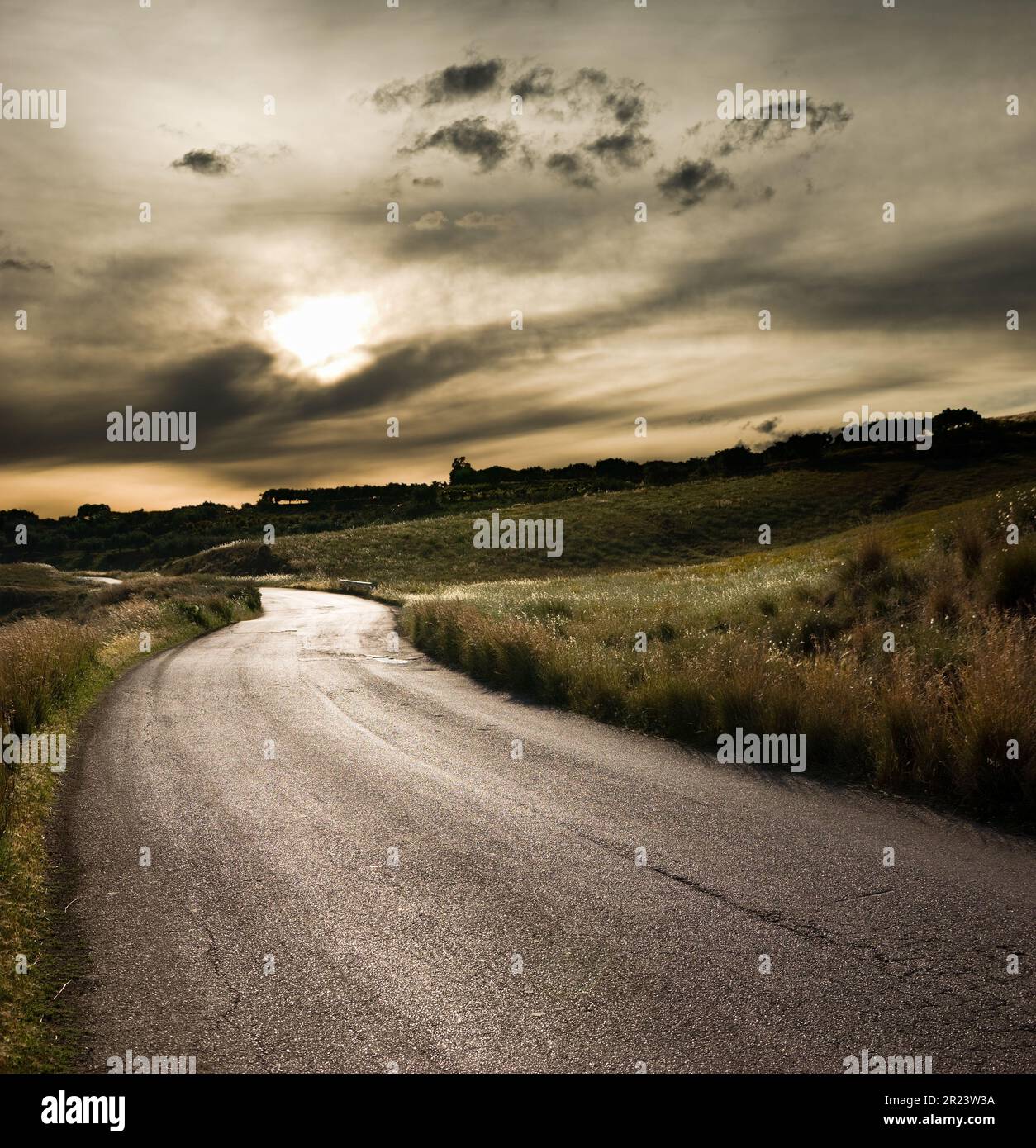 dark and moody landscape with winding rural road in Sicily, Italy Stock ...