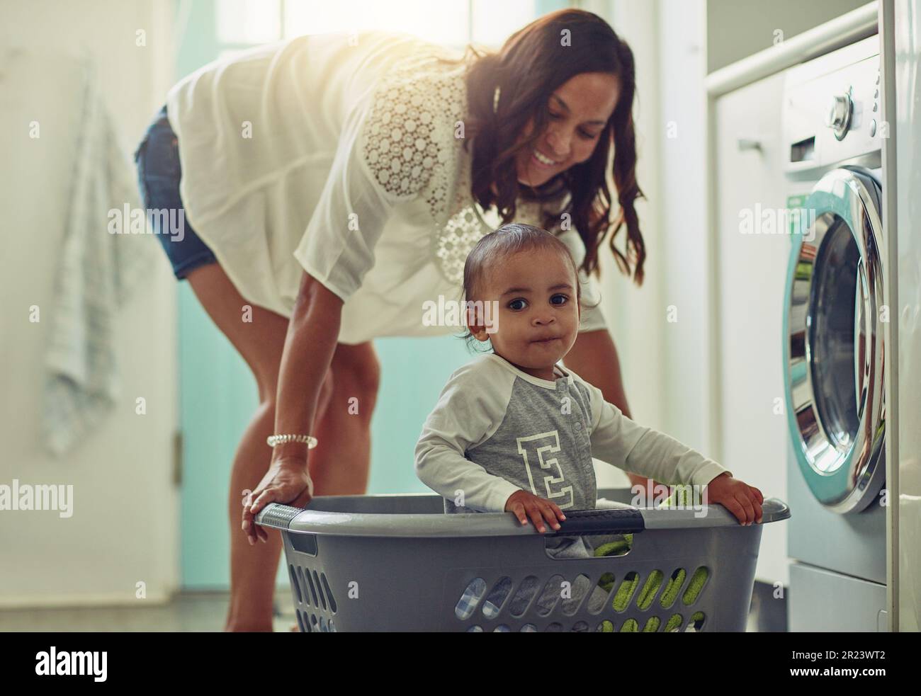 Cleaning, mother and baby playing in basket doing the laundry in their ...