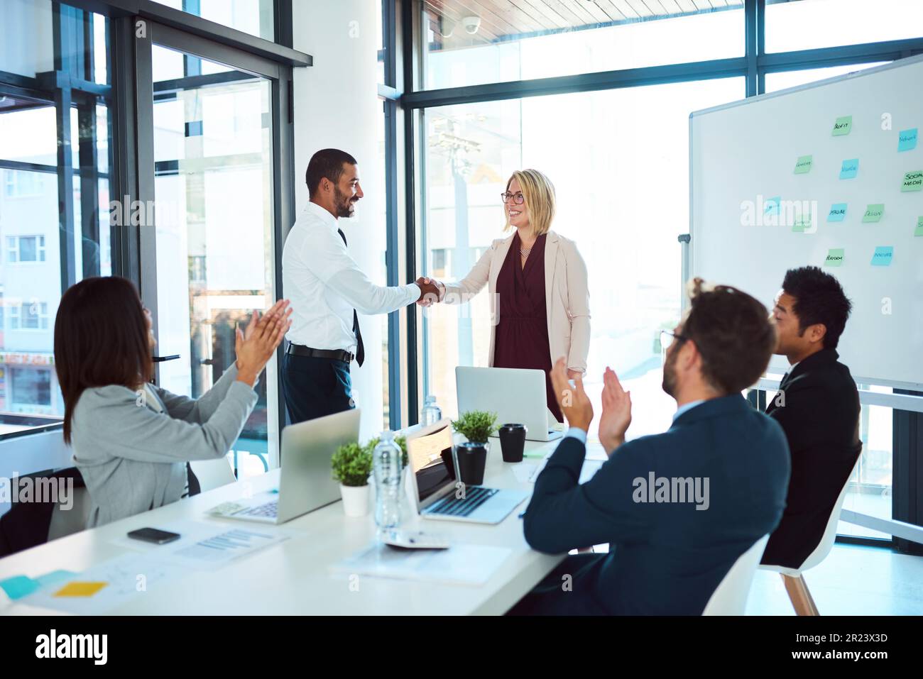 Congratulations, handshake and professional with support at a meeting for teamwork and ...