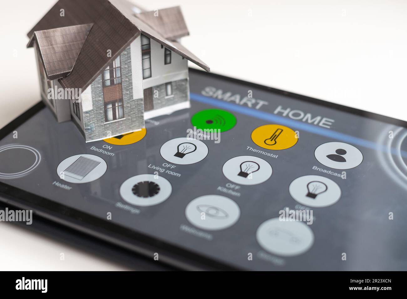 Small house model is on table and icons home electronics devices ...