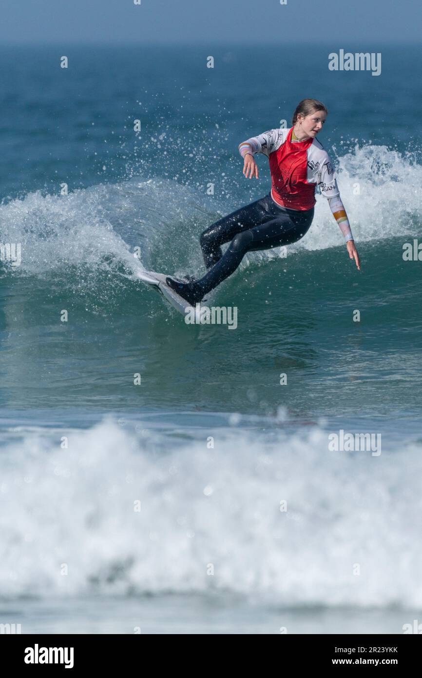 A female surfer competing in a surfing competition at Fistral in ...