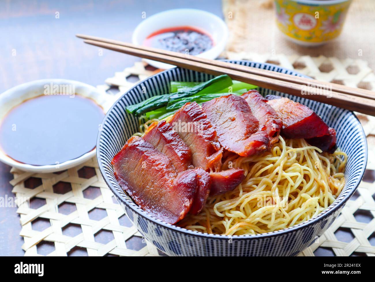 Chinese barbecue roast pork noodle (Char Siu) in a bowl on bamboo ...
