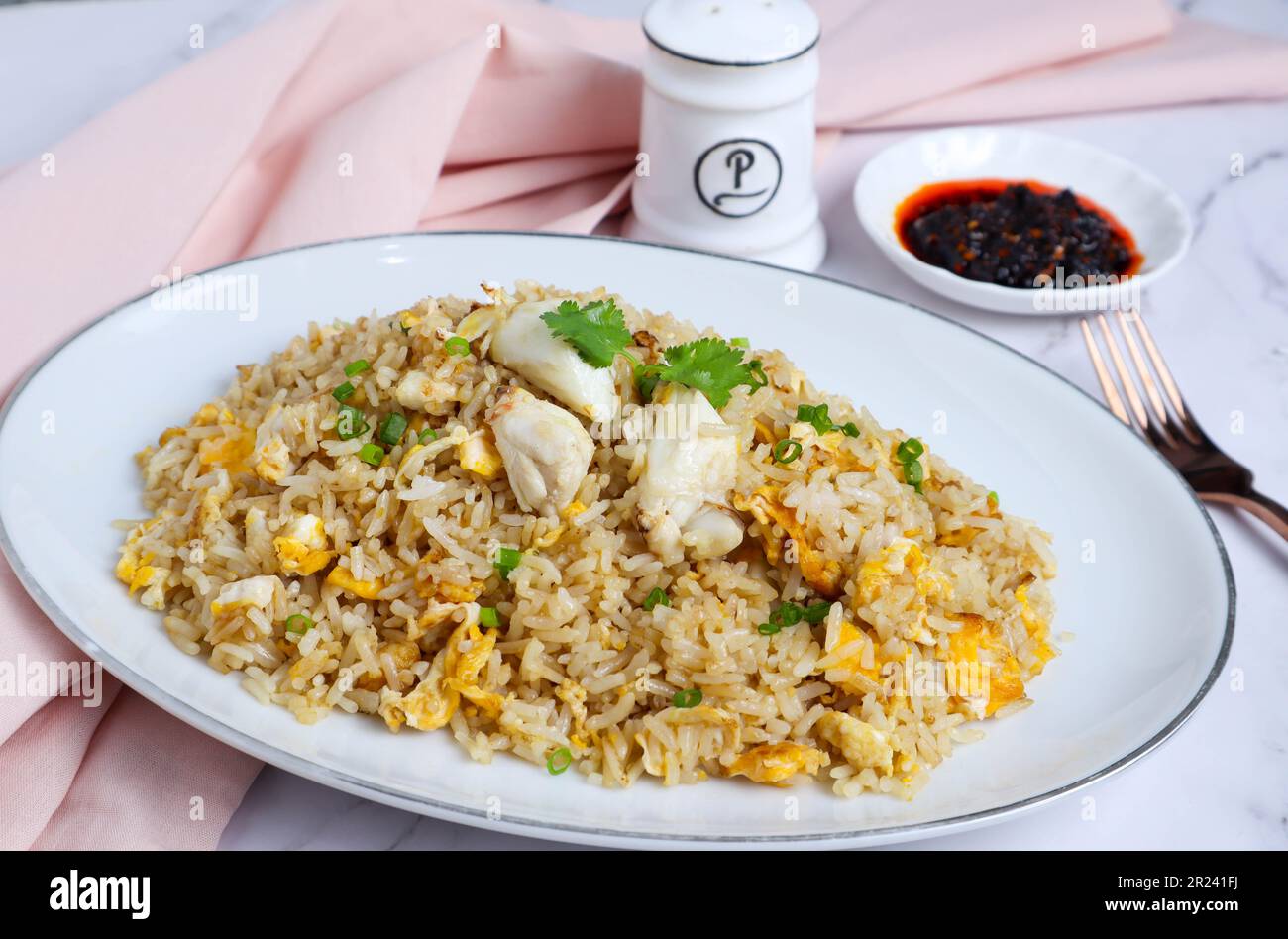 Crab Fried rice - Asian food served in a white place of marble table at ...
