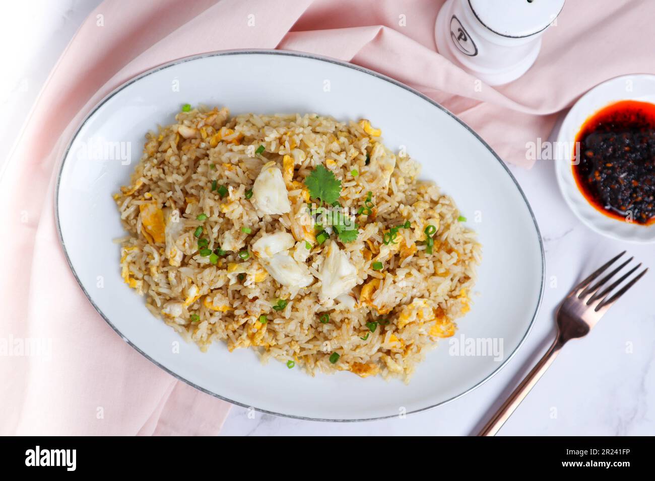 Crab Fried rice - Asian food served in a white place of marble table at ...