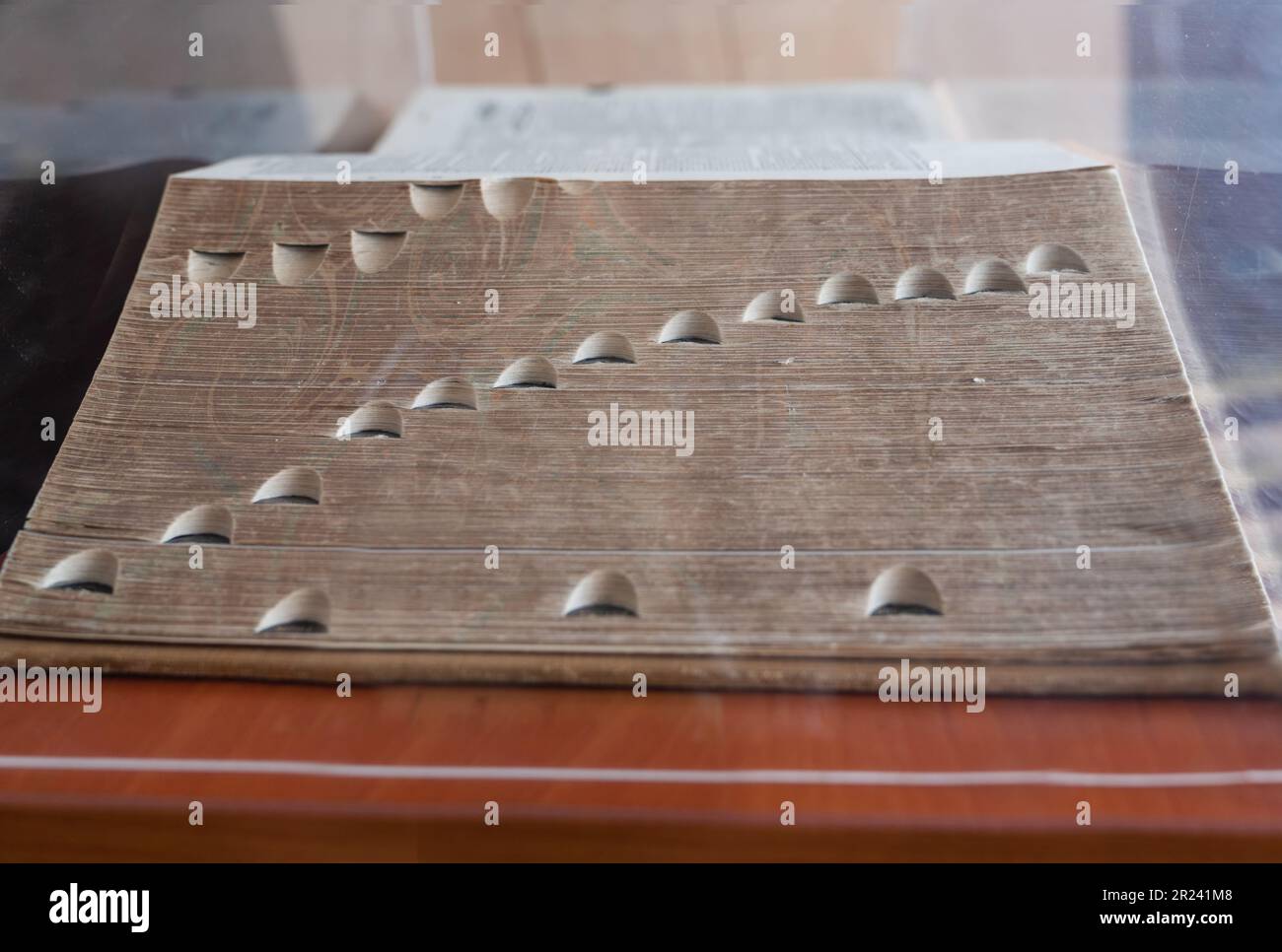 Side view of an old thick dictionary, with recesses, hollow on the side ...