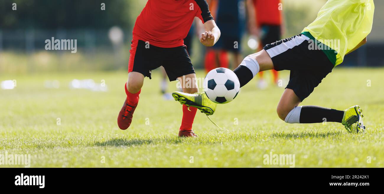 Soccer defensive player in action during a slide tackle. Two ...
