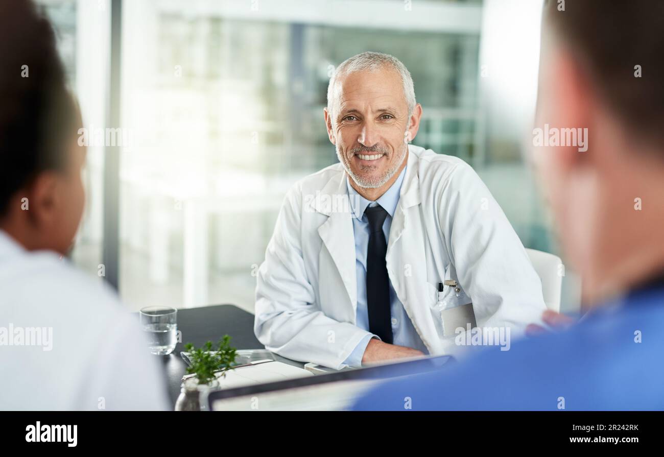 Portrait, man and doctor with team in office for meeting, clinic ...