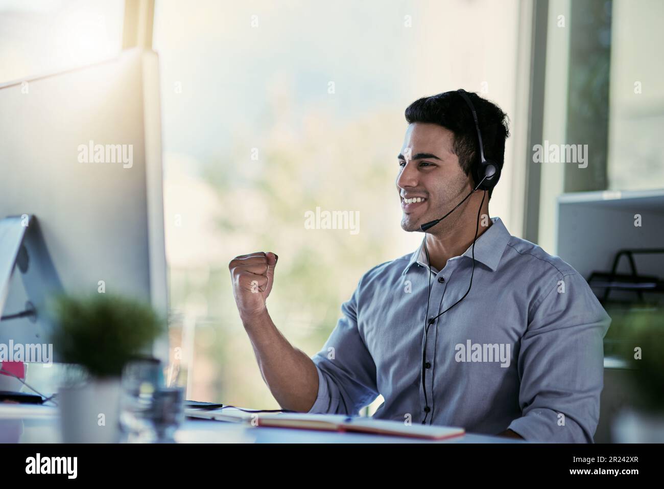 Callcenter agent, smile and winning, man with advice, celebration and ...